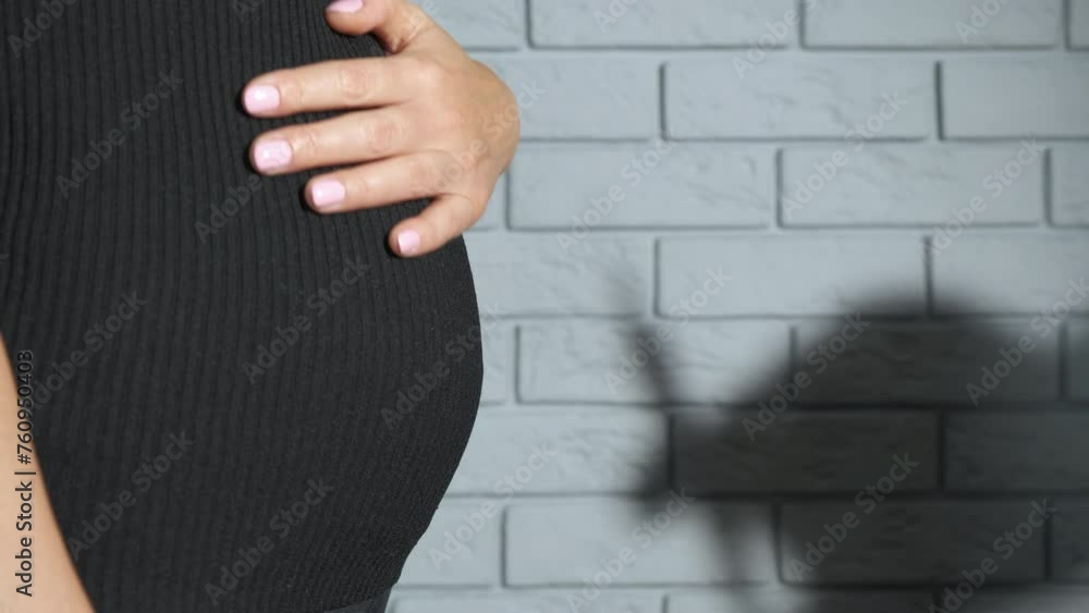 Syringe by lady pregnant belly. A view of syringe by pregnant stomach ...