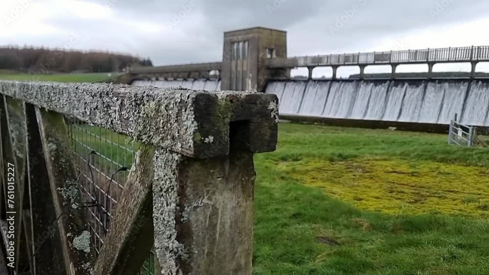 Cefni dam slow motion dolly across wooden gate to reveal concrete wall ...