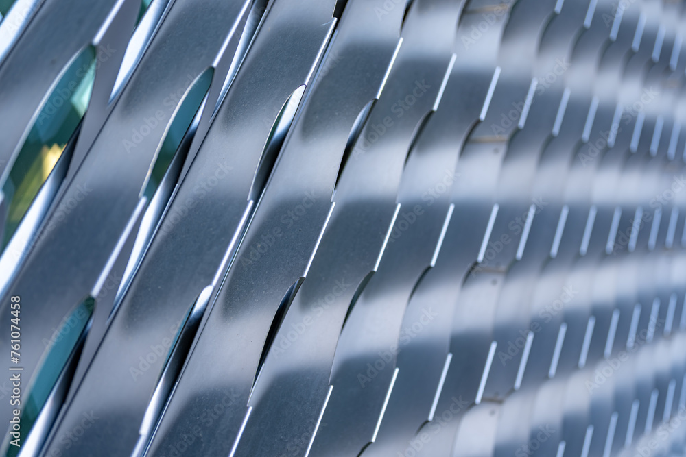 Close-up photo of silver gray angled exterior aluminum louvers over a ...