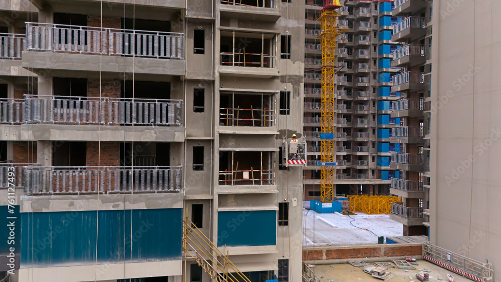 cradle with climbers, professional builders on a scissor lift ...