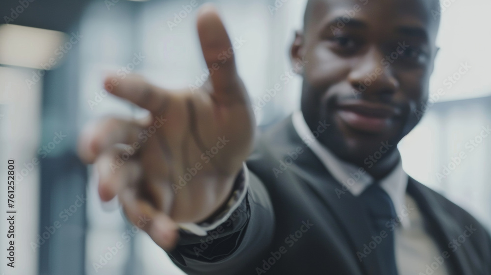 A businessman reaching out for a handshake, signifying a warm welcome ...