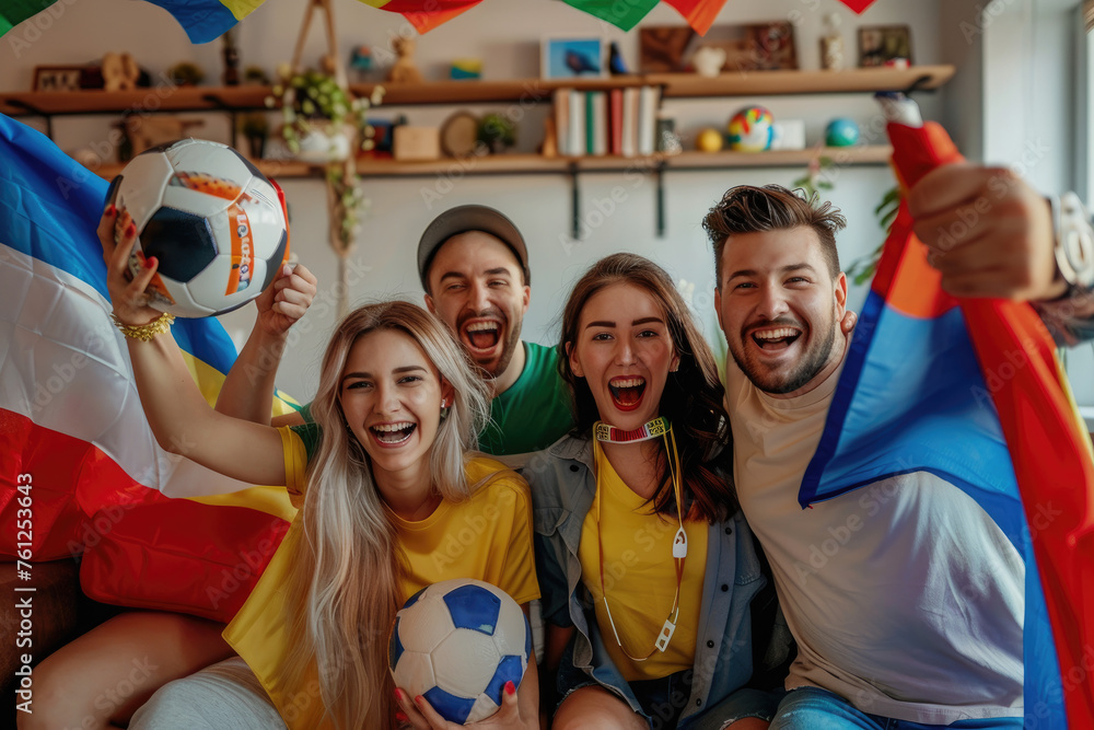 A group of happy friends were cheering for their football team, holding ...