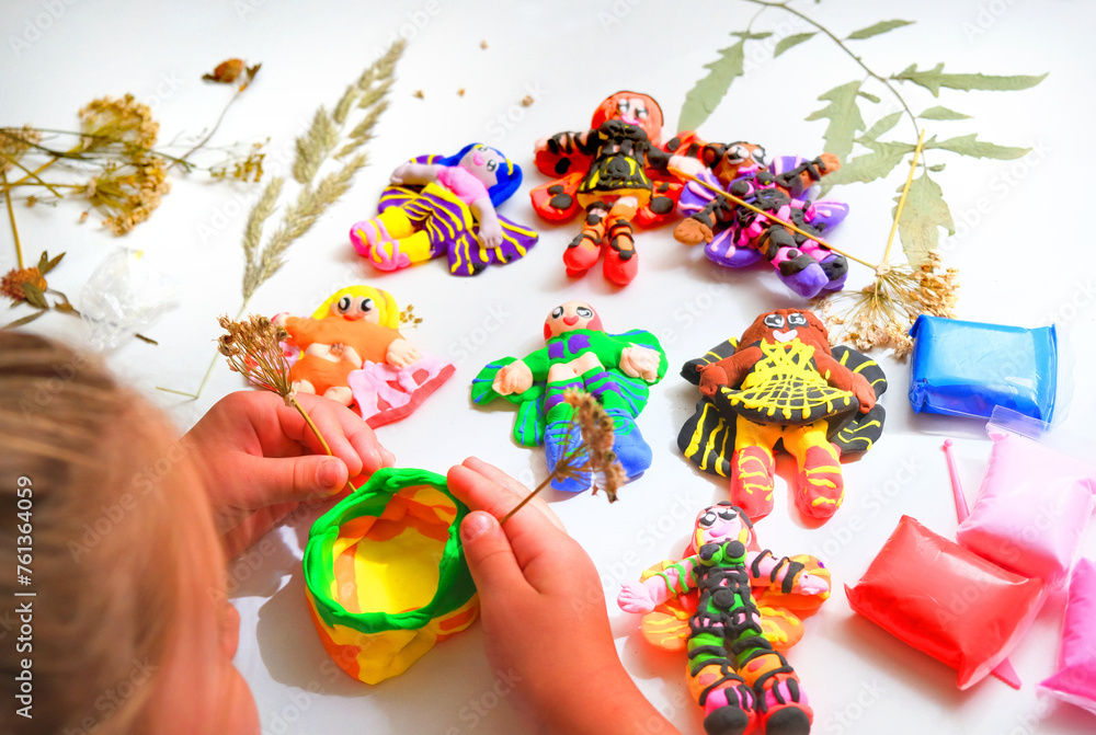 Child modeling from plasticine and clay, using nature materials ...