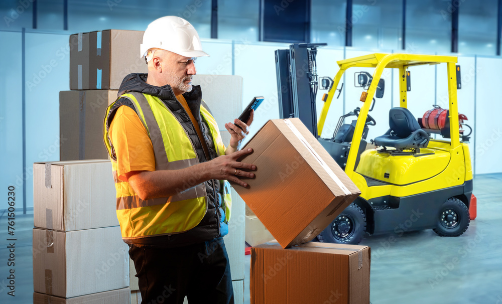 Warehouse Operator Scanning Packages with Handheld Device Beside Yellow ...