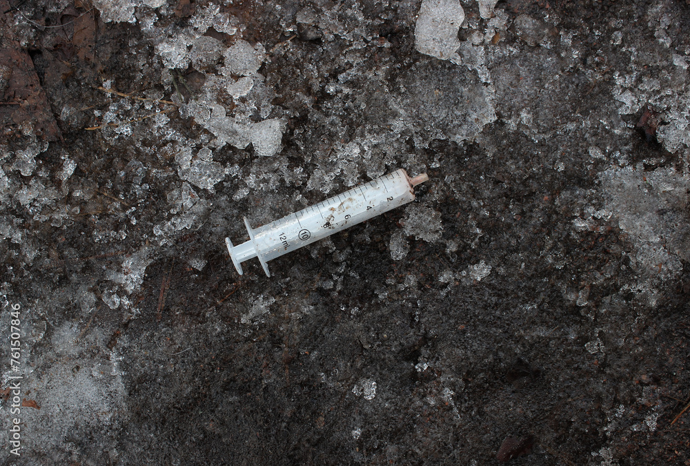 Bloodied syringe thrown away by a street drug addict after an injection ...