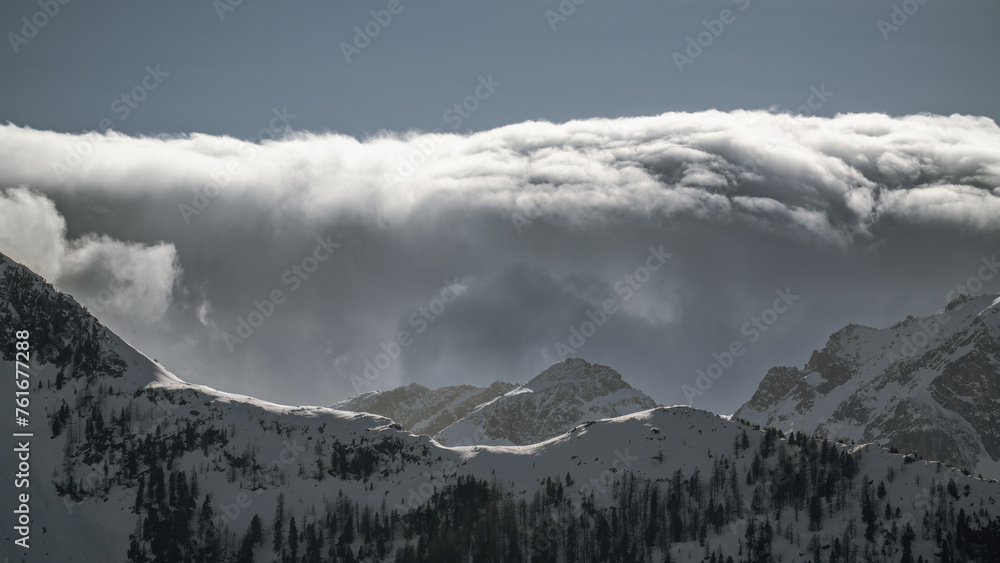 strong south wind and foehn clouds in the alps at a sunny spring day in ...