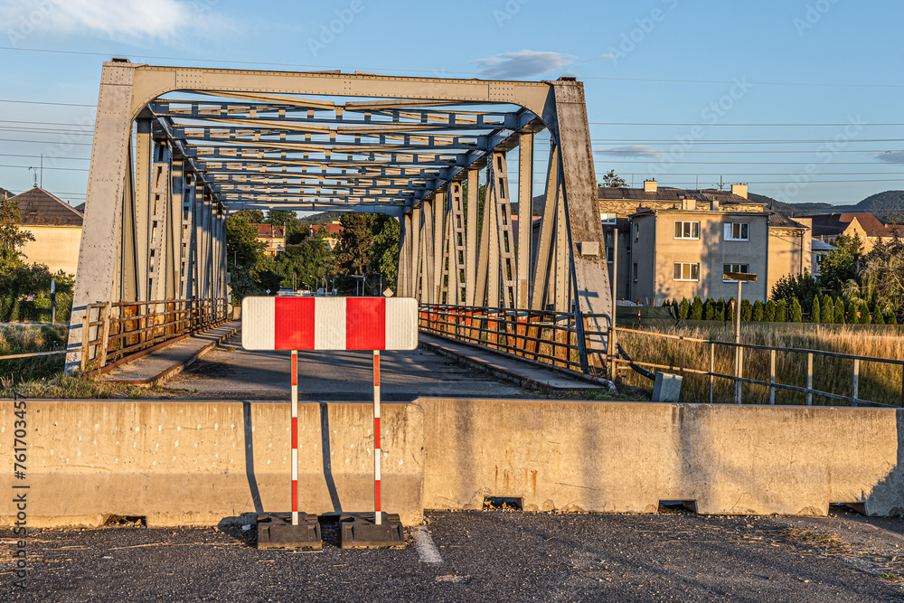Damaged bridge, closed with concrete barriers and traffic sign. Stock ...
