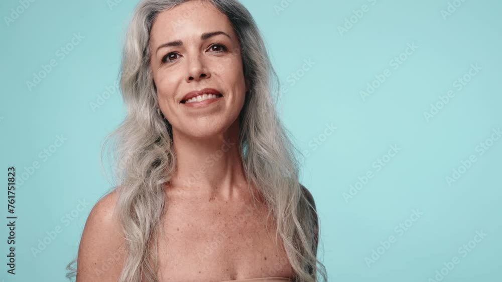 Confident and beautiful middle-aged woman with long silver hair ...