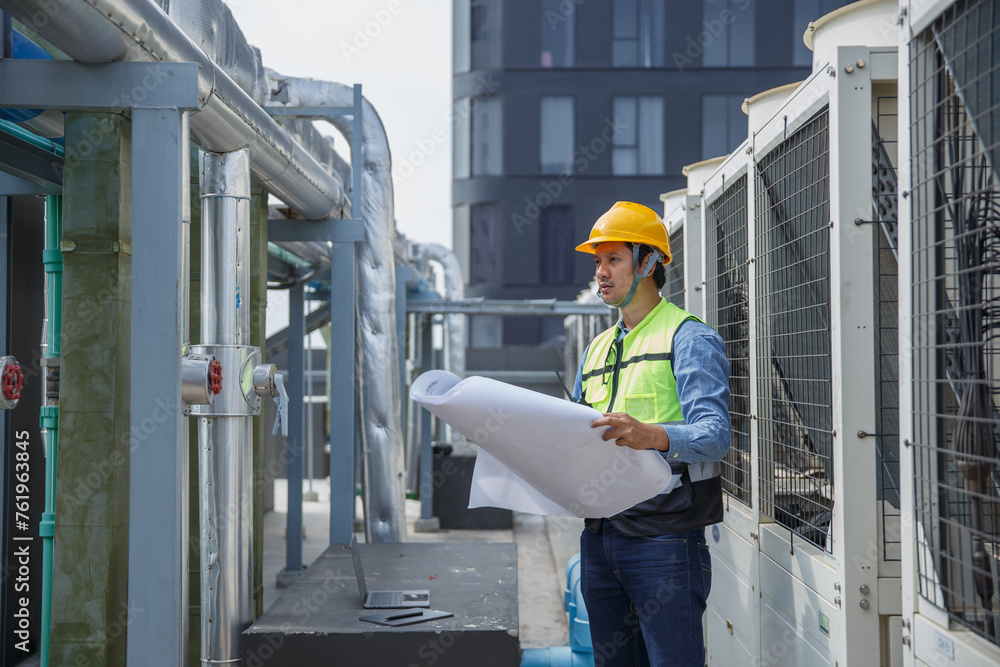 Male operator worker reading blueprint checking drawing plan cooling ...