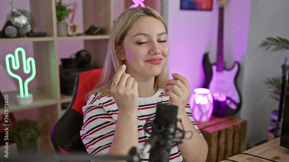 Sneaky young woman streamer, beautiful blonde doing money gesture with ...
