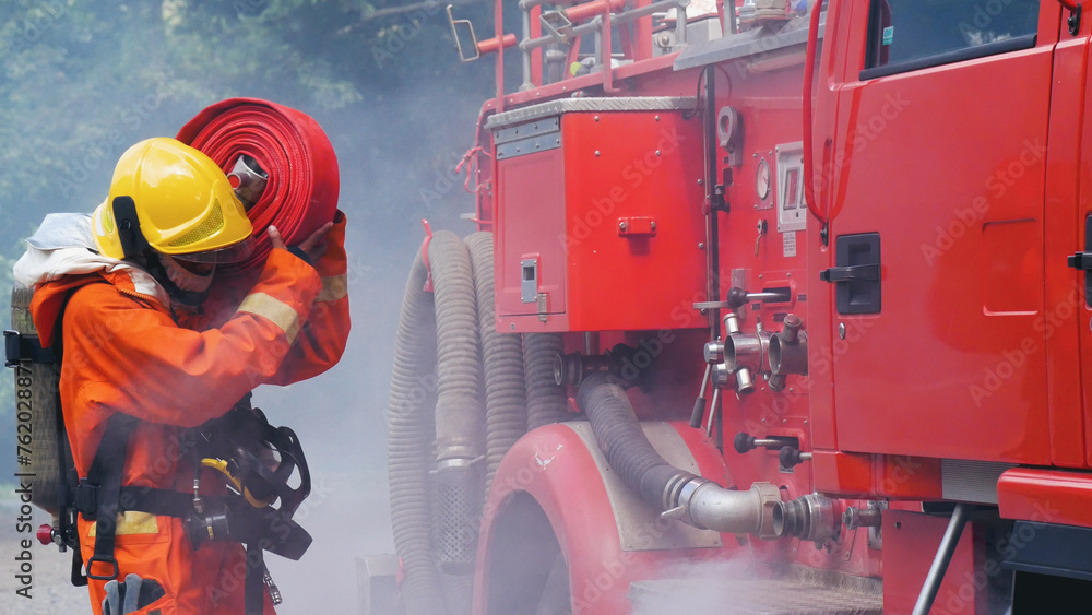 Fireman prepare equipment at fire engine truck. Man hand connect water ...
