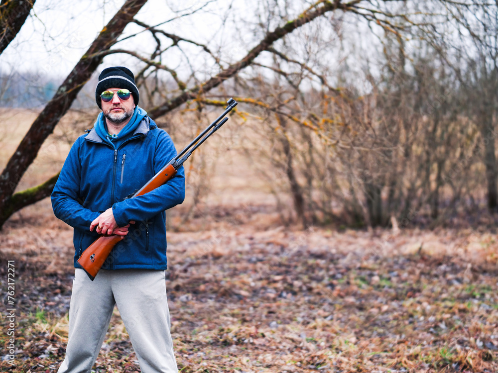 Man with old style rifle with wooden base and stock and simple iron ...