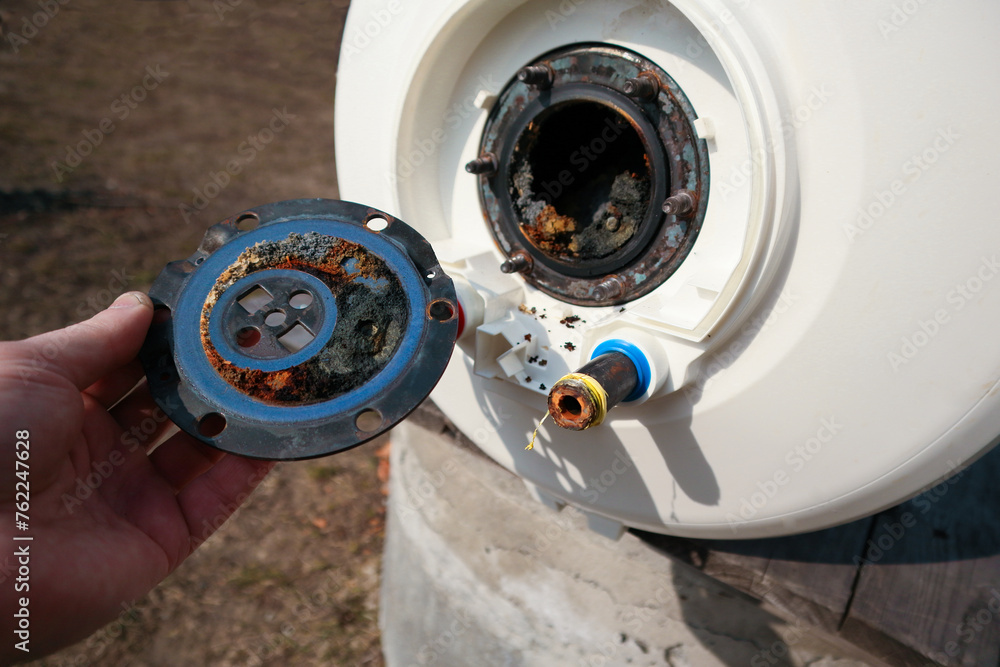 Plumber checking a boiler. Residential hot water heater service concept ...