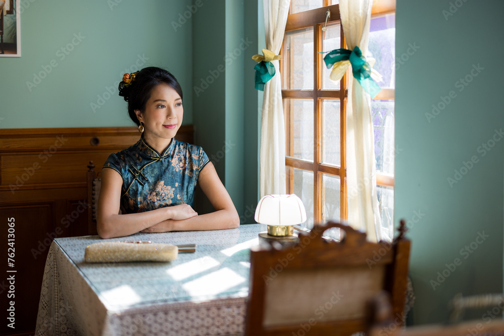 Woman wear traditional chinese cheongsam in the vintage restaurant ...