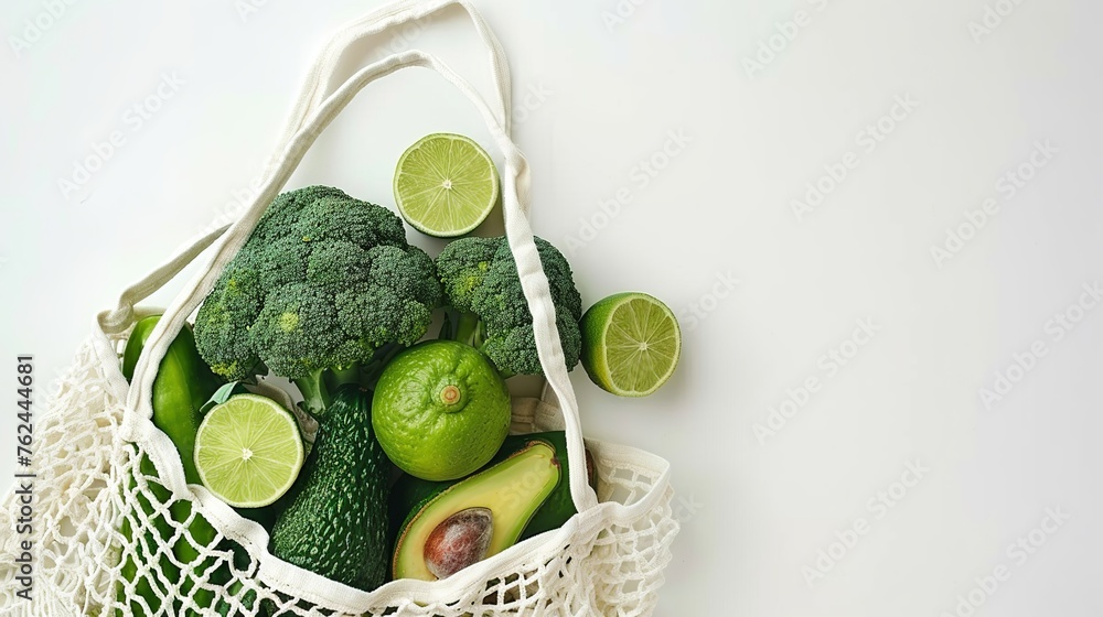 A white net bag filled with broccoli, avocados and limes, photo for an ...