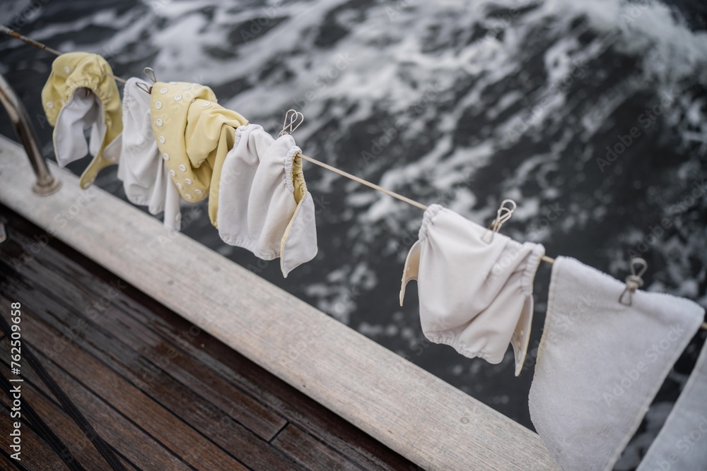 clothes drying on a washing line on a yacht boat traveling over the ...