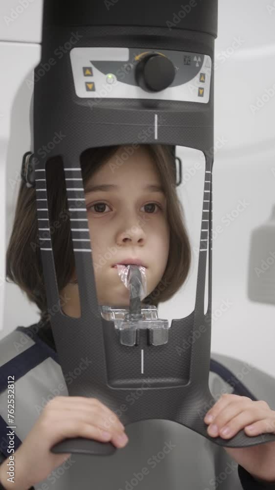 A dental X-ray machine takes a picture of the baby's baby teeth and jaw ...