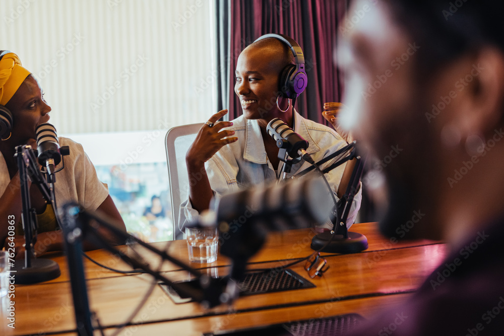 Engaging podcast recording session with smiling hosts in studio Stock ...