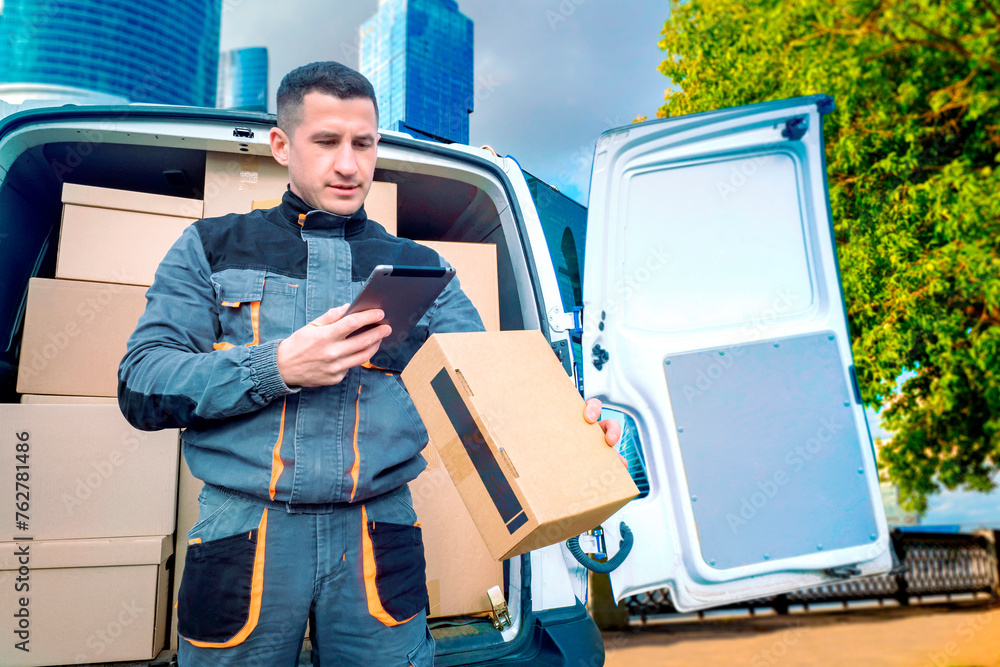 Man courier in downtown. Delivery guy holds package. Courier stands ...
