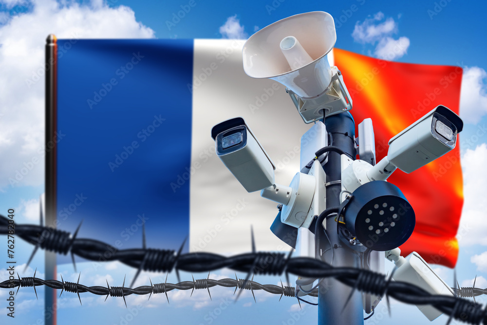 Cameras near french flag. Barbed wire is metaphor for state border ...