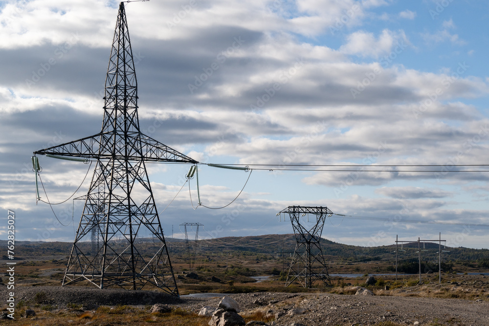 A metal electric utility pole with electrical wires, transmission lines ...