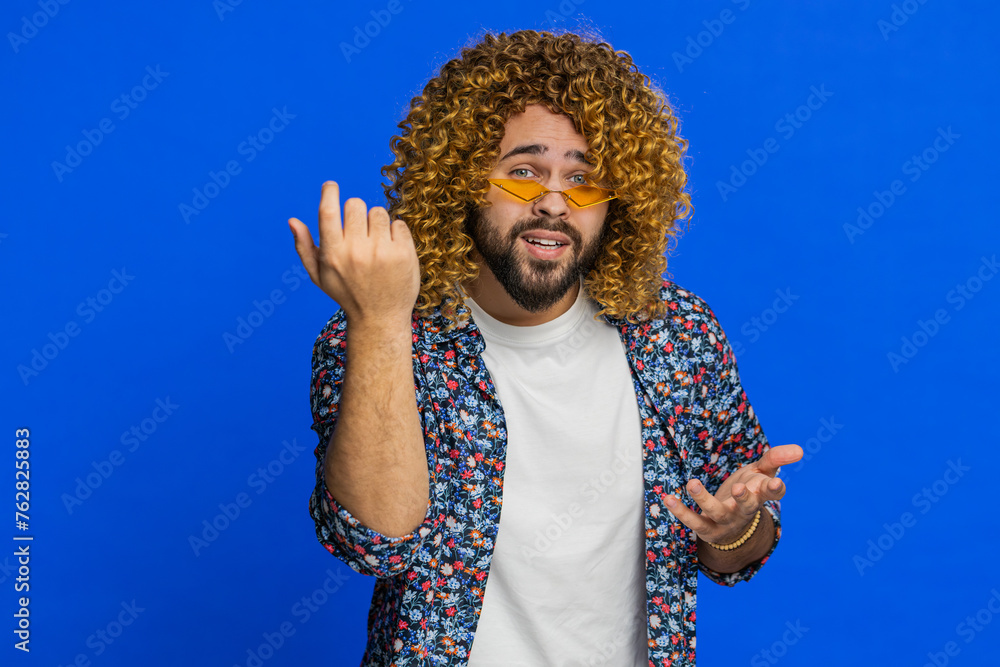Knock-knock who is there. Confused amazed man with curly hairstyle wig ...