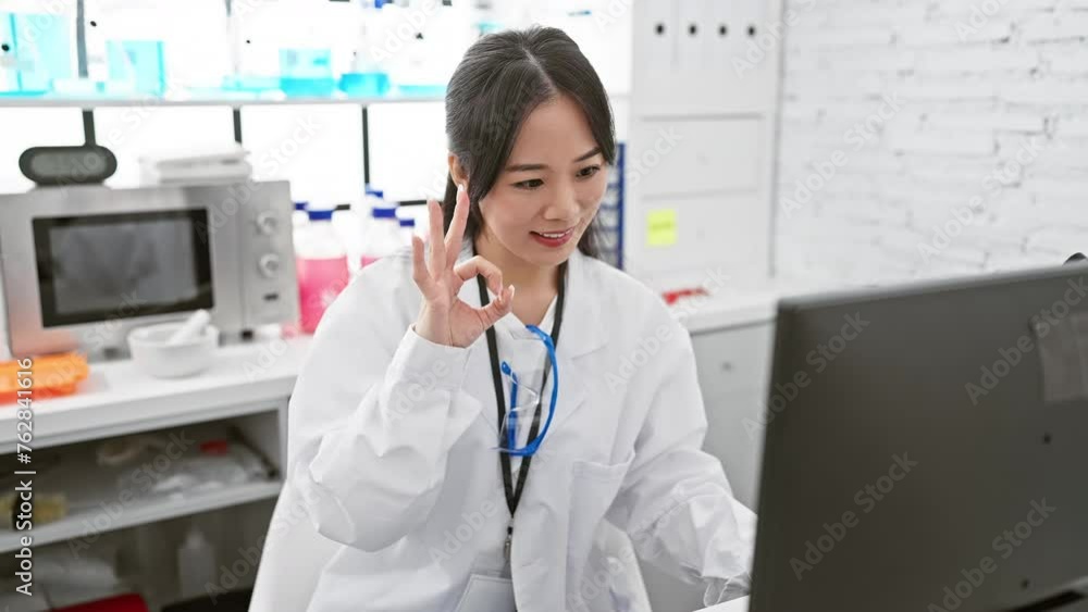 Confident young chinese scientist woman, radiant with success, flashes ...