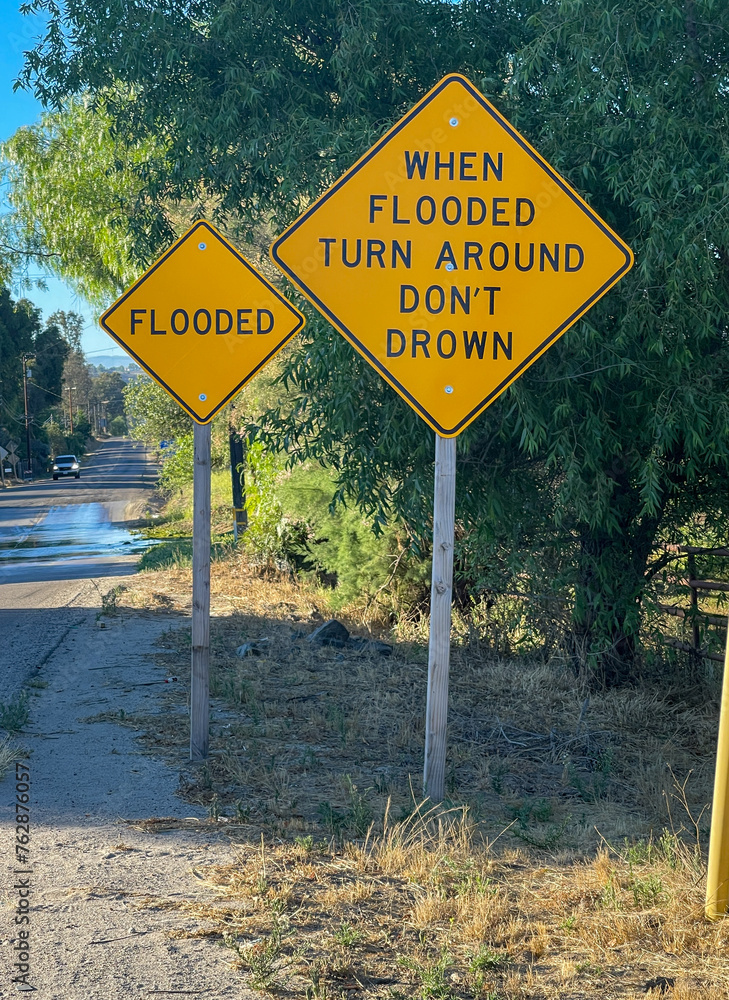 Flooded and when flooded turn around don't drown signs on the side of ...