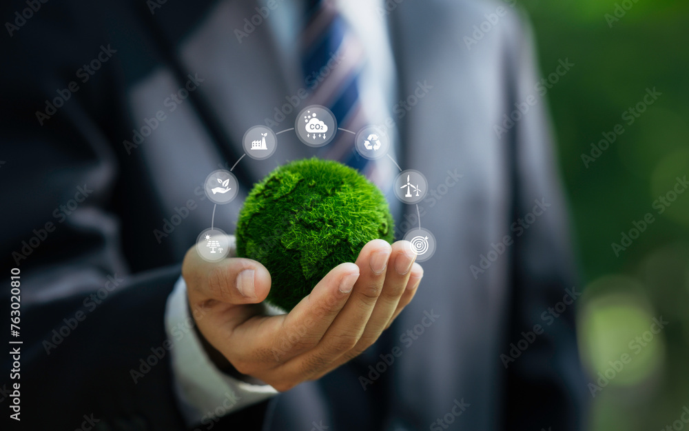 Net zero and carbon neutral concept. Businessman holding world green ...