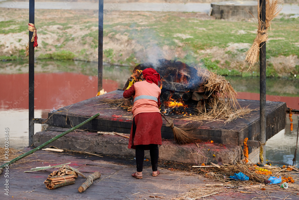 Staff employee of Pashupatinath Temple complex overseeing for funeral ...