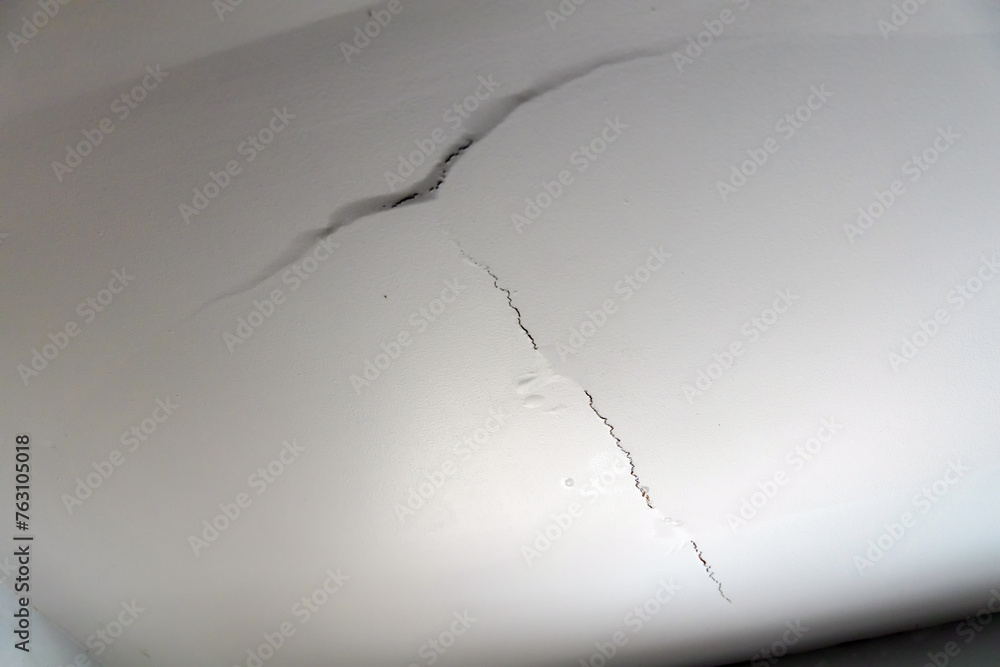 Ceiling panels cracked in house from water pipes damaged or rainy ...