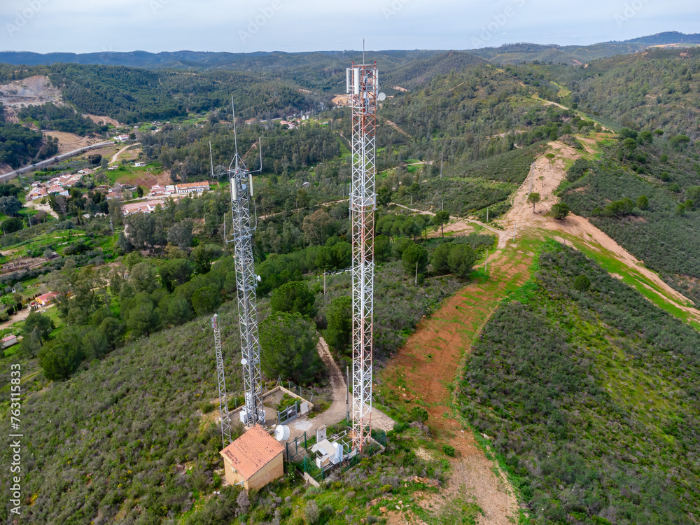 Aerial drone view of GSM, 4G, 5G and radio telecommunication towers on the top of a mountain ...