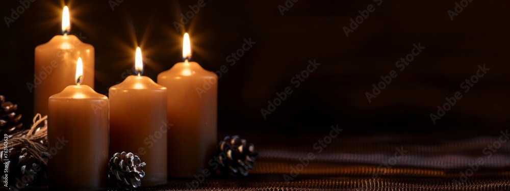 Fourth advent, four candles - candlelight on dark brown panorama ...