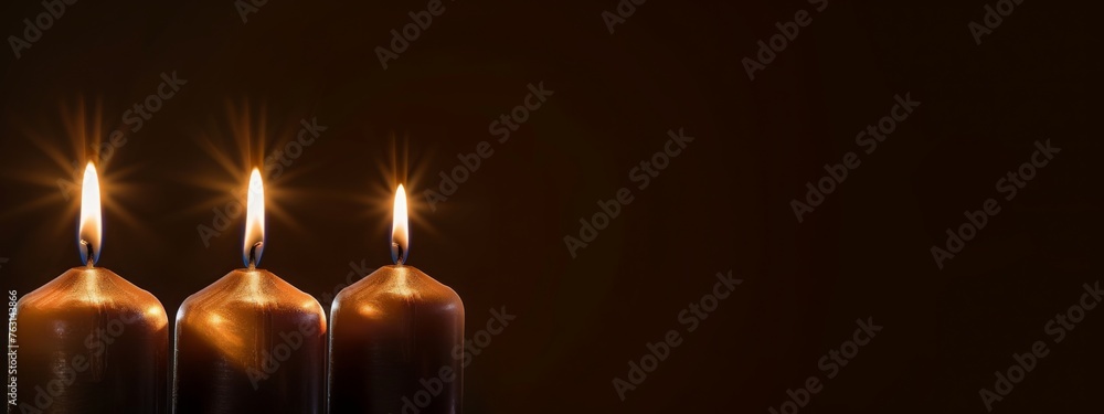 Fourth advent, four candles - candlelight on dark brown panorama ...