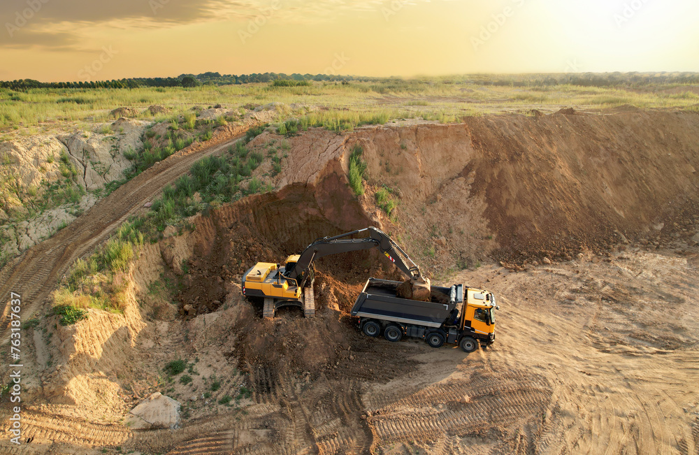 Excavator load sand into truck in opencast. Mining excavator in open ...