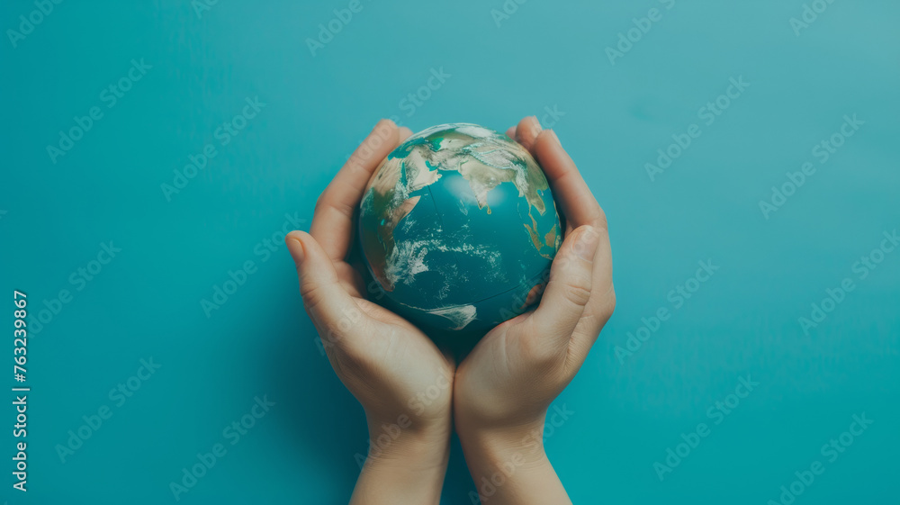 Hands cradle a delicate Earth globe, symbolizing environmental care and ...