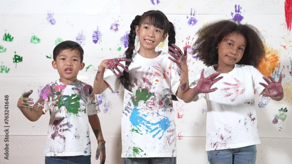 Diverse students put hand up together show colorful stained hands ...