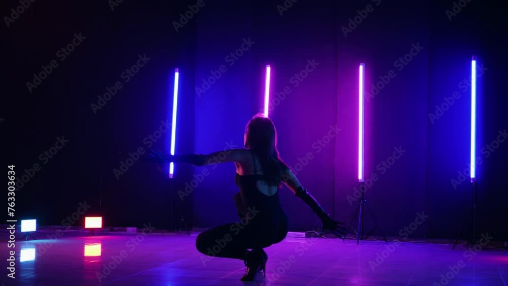 Vibrant neon lit dance floor with woman in motion. Energetic dance ...