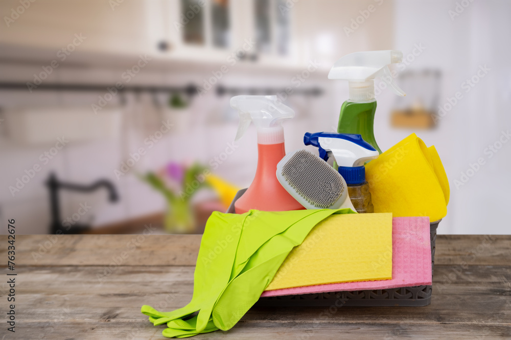Basket with cleaning items on blurry kitchen background, spring home ...