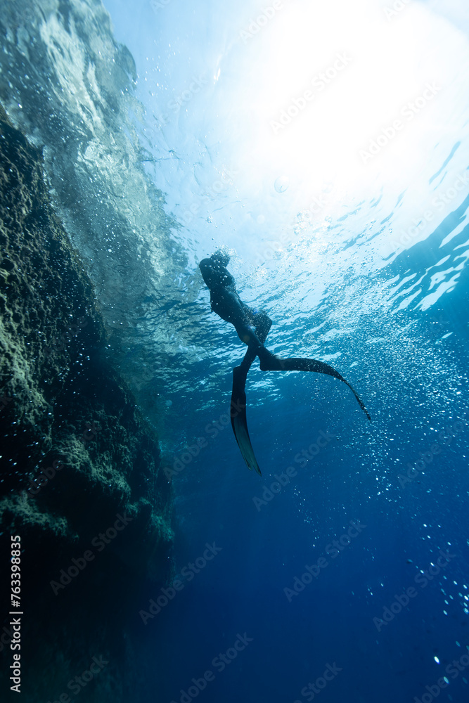 Freediver Swimming in Deep Sea With Sunrays. Young Man Diver Eploring ...