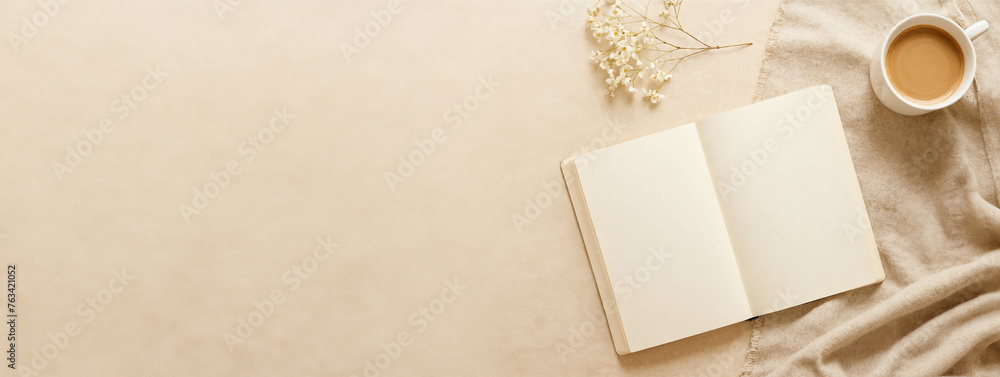 Blank book with open pages template laying on linen cloth with a cup of ...