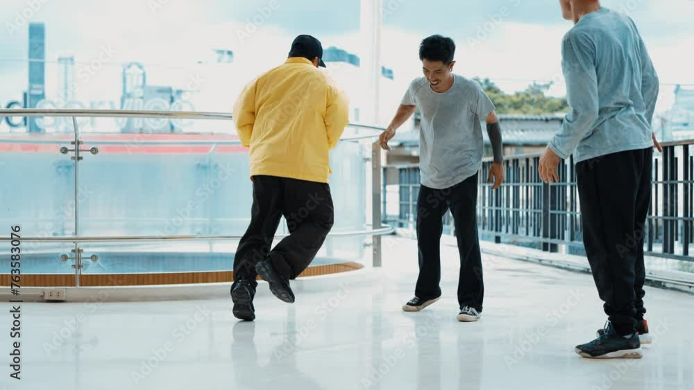 Hip-hop teenager group perform b-boy dance at mall corridor with city ...