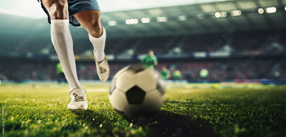 Male legs, football player in motion on filed dribbling ball, playing ...