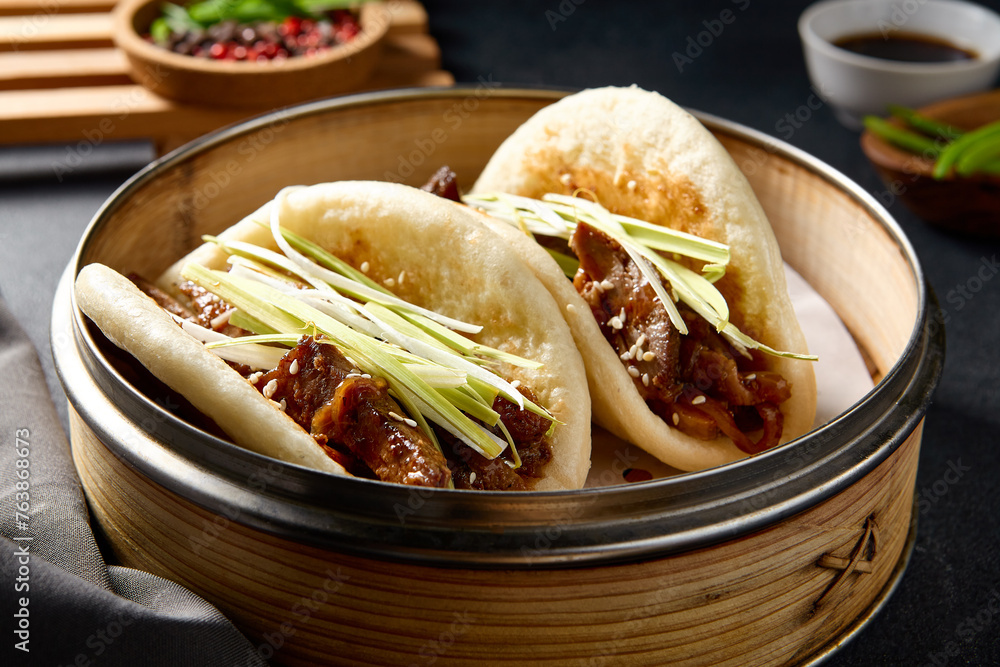 Elegant presentation of Peking duck Bao buns garnished with fresh green ...