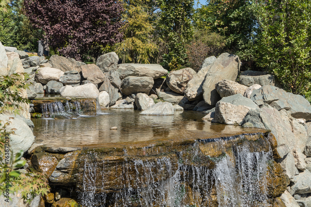 Triple waterfall in the Japanese Garden. Water falls from a height of 7 ...
