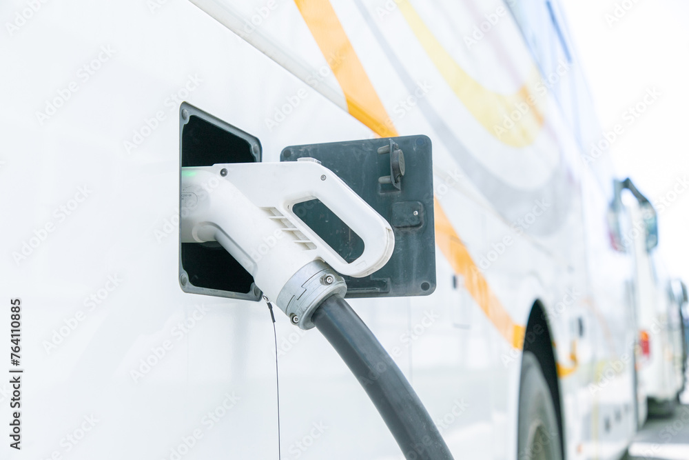 A electrical car in charging position connected to charging piles ...