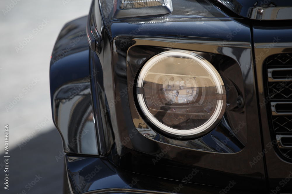 Headlights and front wheel of a modern car close-up, auto design. Stock ...