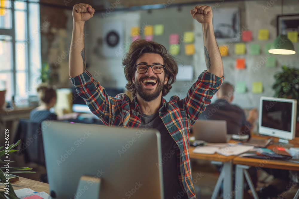 A man is smiling and holding his hands up in the air in front of a ...