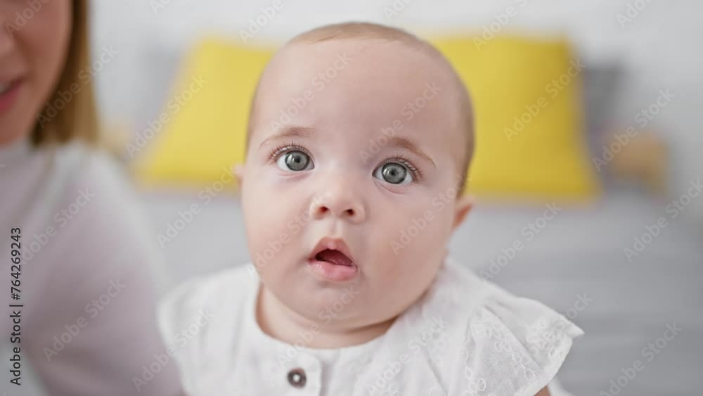 Confident mother and baby daughter sharing a joyful moment, sitting ...