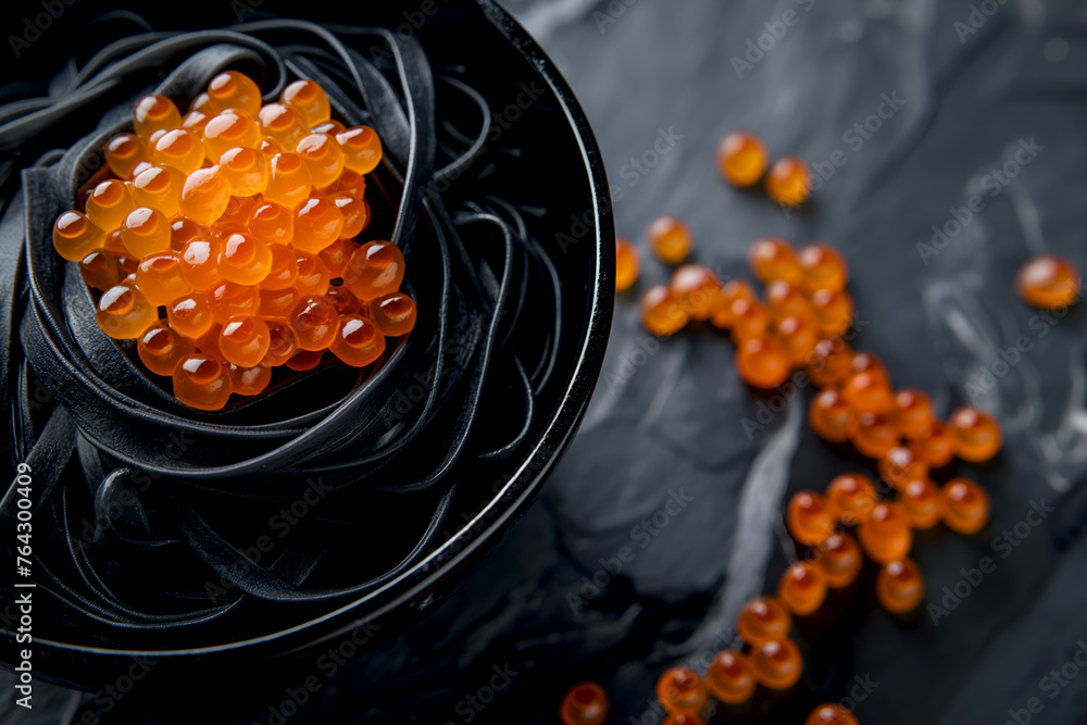 Black pasta with red caviar. Squid ink pasta with salmon roe on dark ...